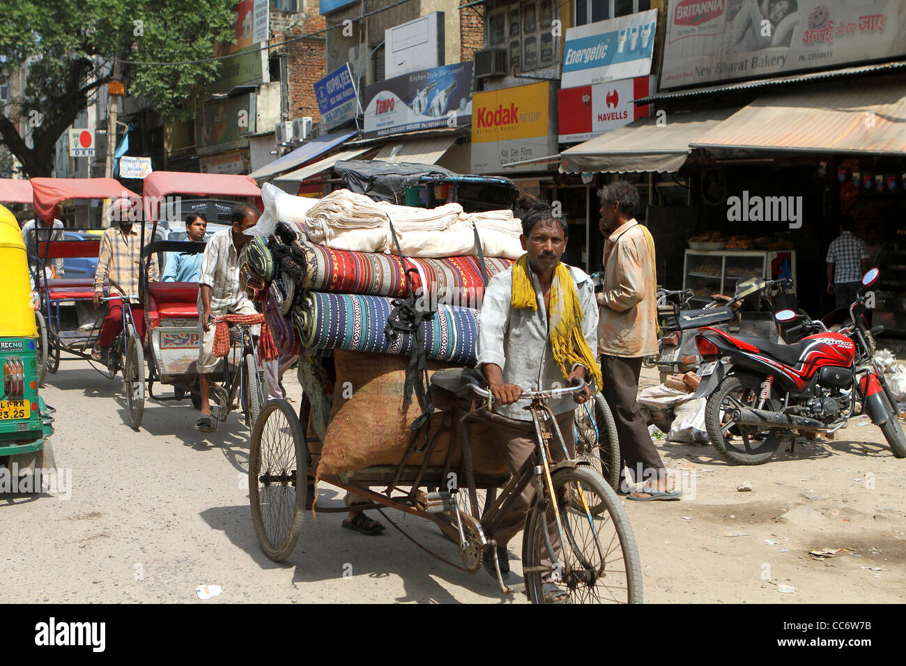 Indian pedal rickshaw driver with a heavy load. Delhi. India Stock ...