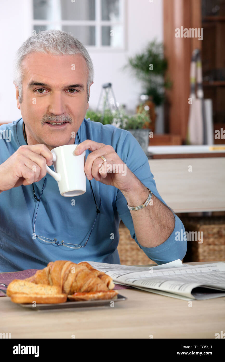 Man drinking tea for breakfast Stock Photo - Alamy