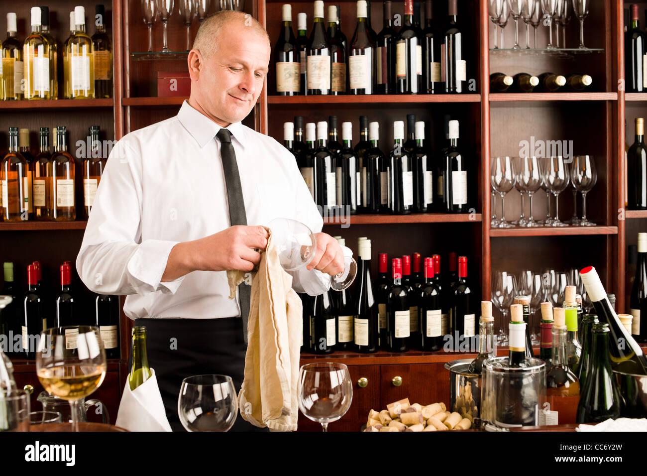 At the bar - waiter clean glass with dish clove restaurant Stock Photo ...