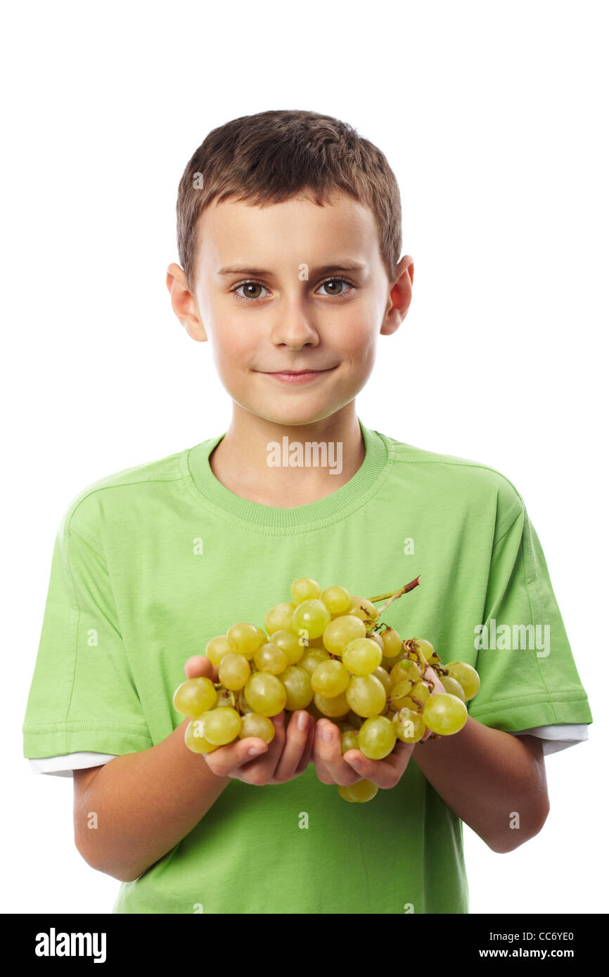 Boy with a cluster of ripe yellow grapes isolated on white background ...