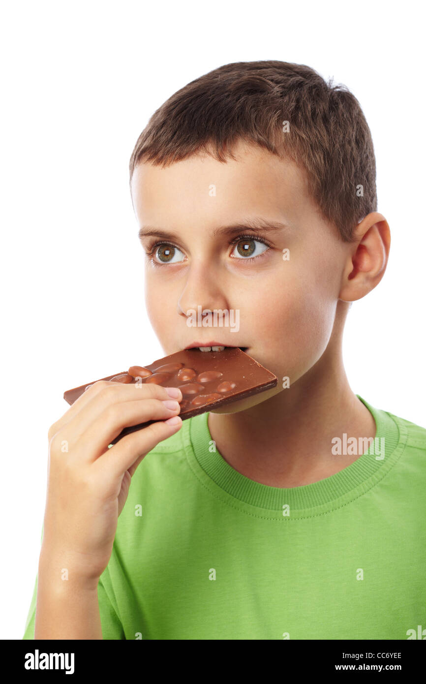 Boy eating chocolate with almonds isolated on white background Stock ...