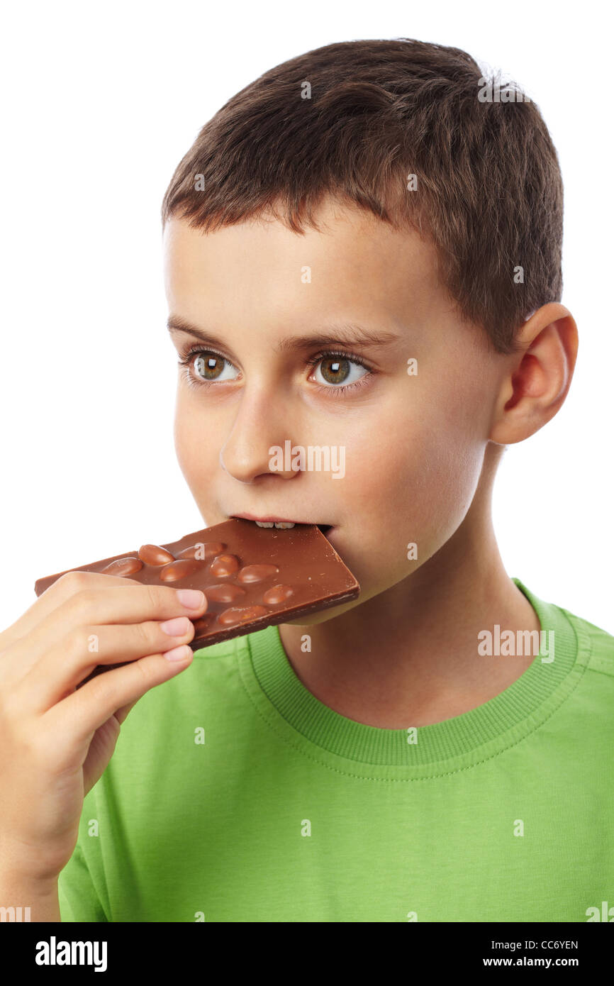 Boy eating chocolate with almonds isolated on white background Stock ...