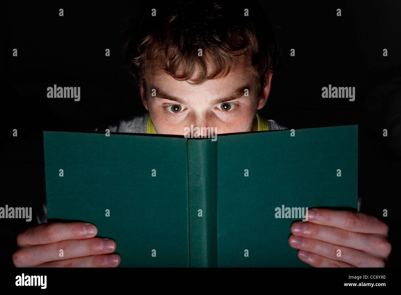 A man reading a book at night Stock Photo - Alamy