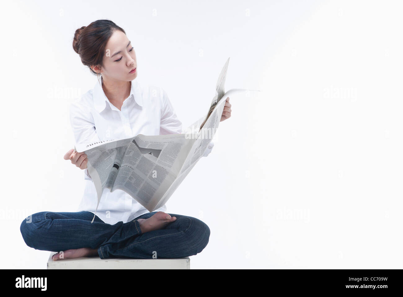 Woman reading newspaper sitting Cut Out Stock Images & Pictures - Alamy