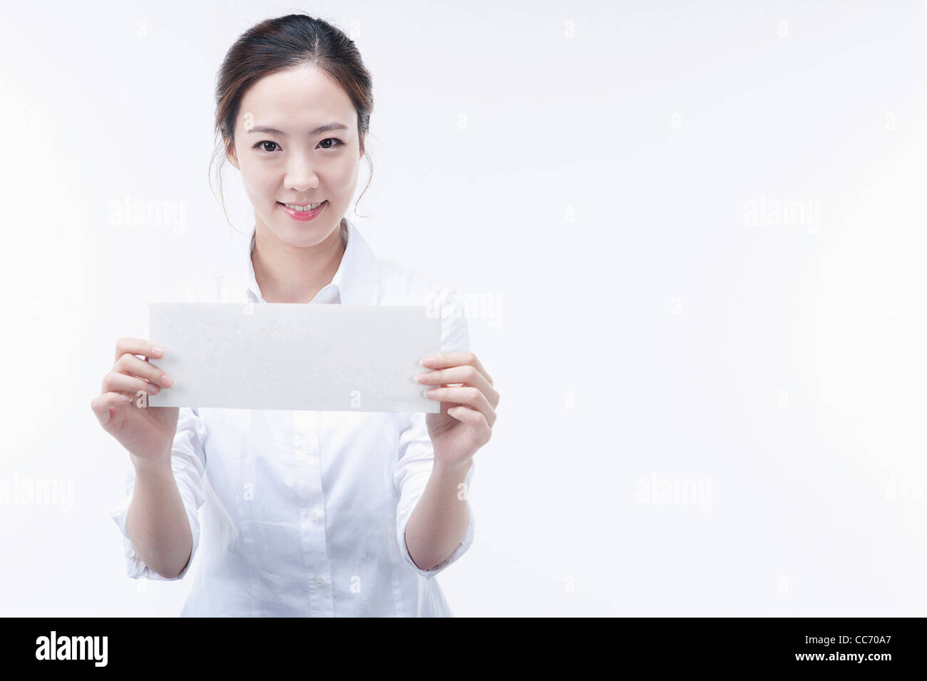 A woman holding white paper Stock Photo - Alamy