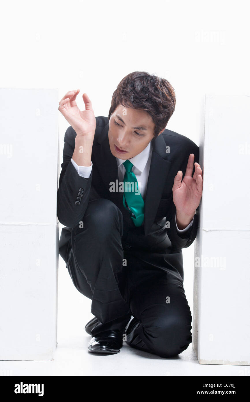 A man stuck between the piled boxes Stock Photo - Alamy