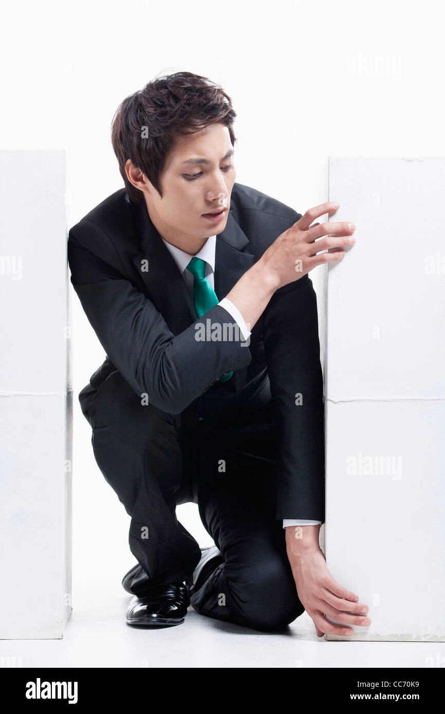 A man stuck between the piled boxes Stock Photo - Alamy