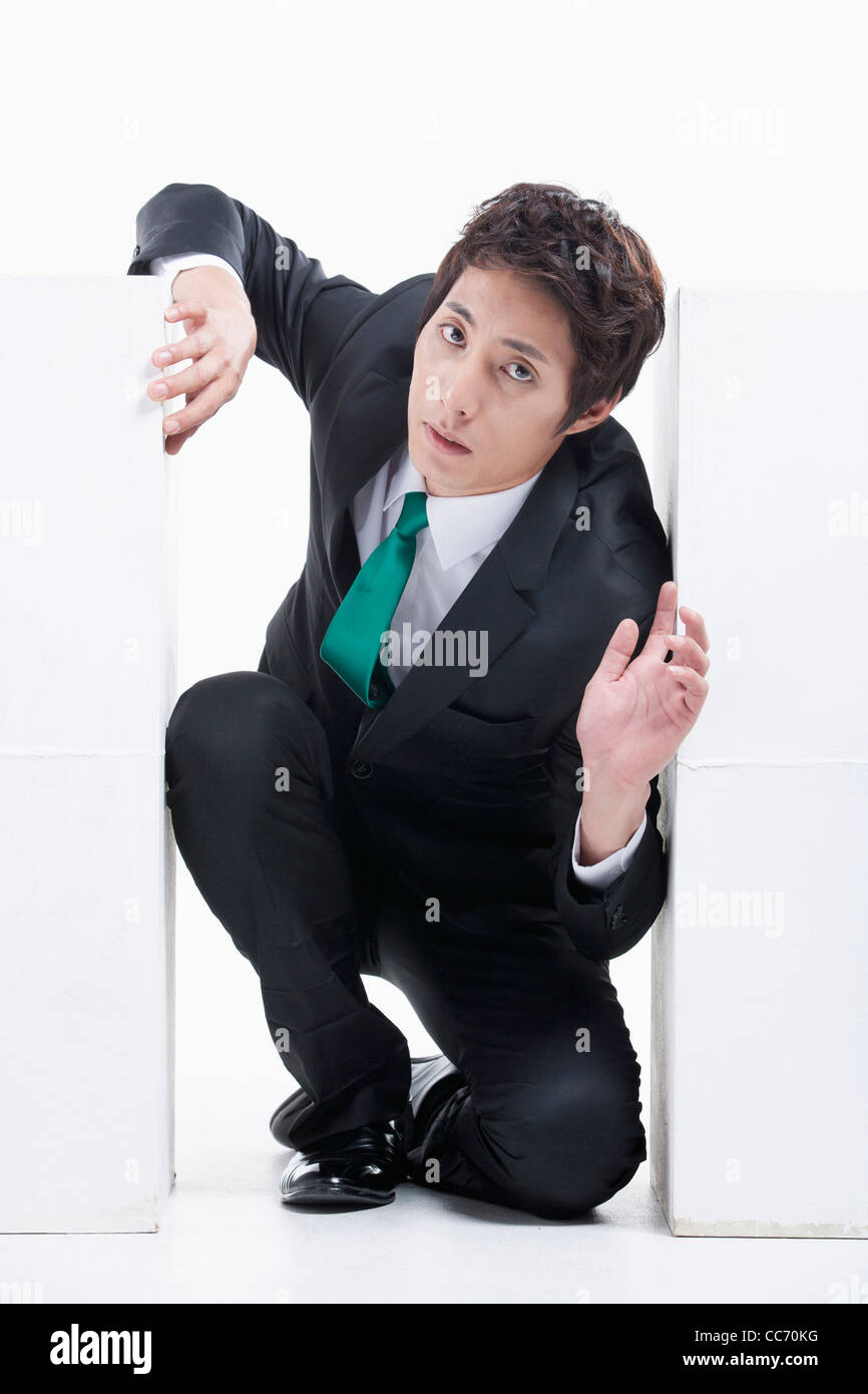 A man stuck between the piled boxes Stock Photo - Alamy