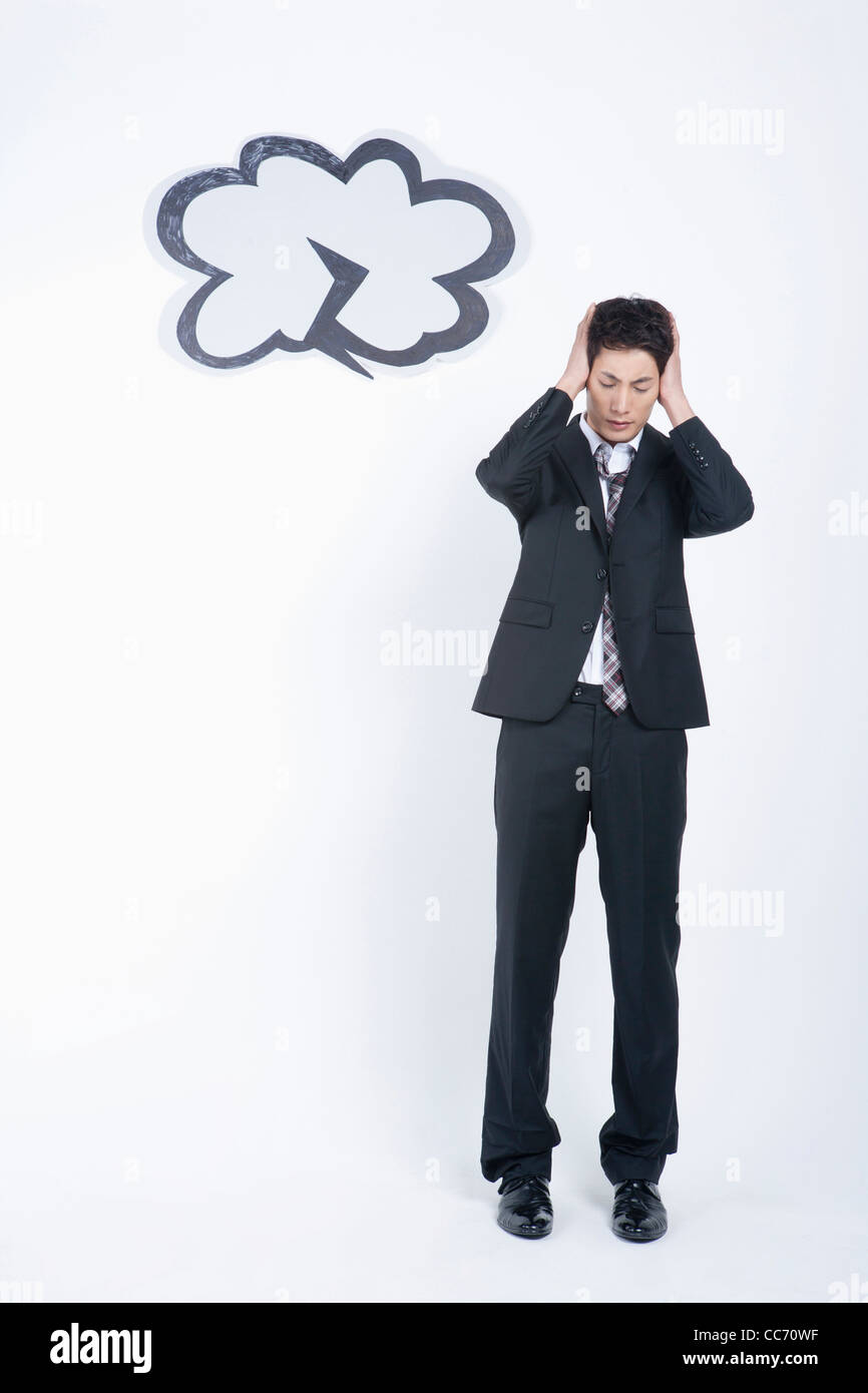 A stressful man having hands on the head with dark lightening cloud ...