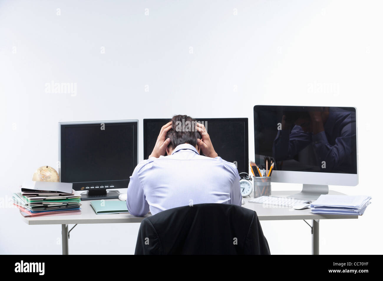 A stressful man in front of monitors Stock Photo - Alamy