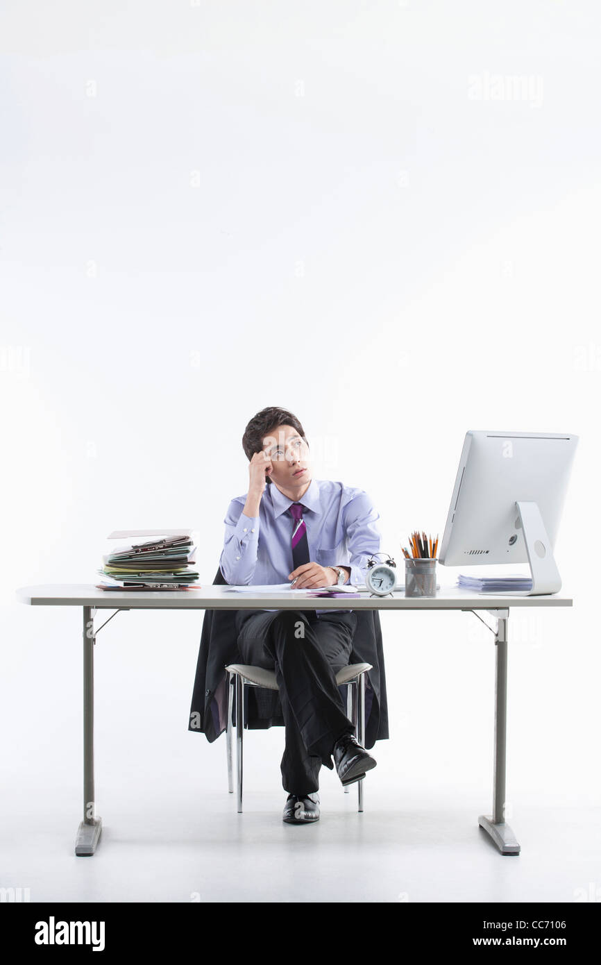 A thinking man while sitting on his desk Stock Photo - Alamy