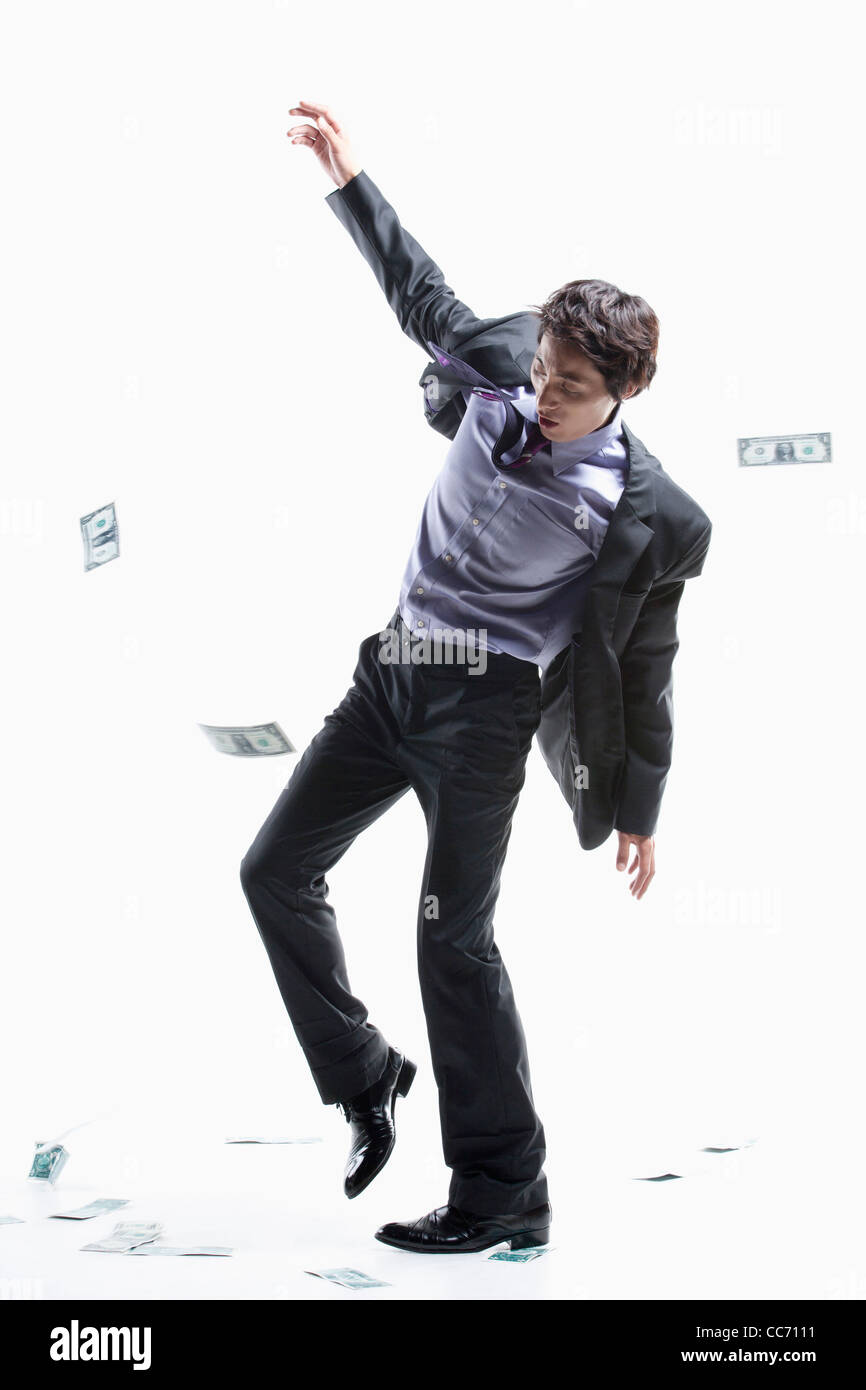 A man hard to walk forward and flying money Stock Photo - Alamy