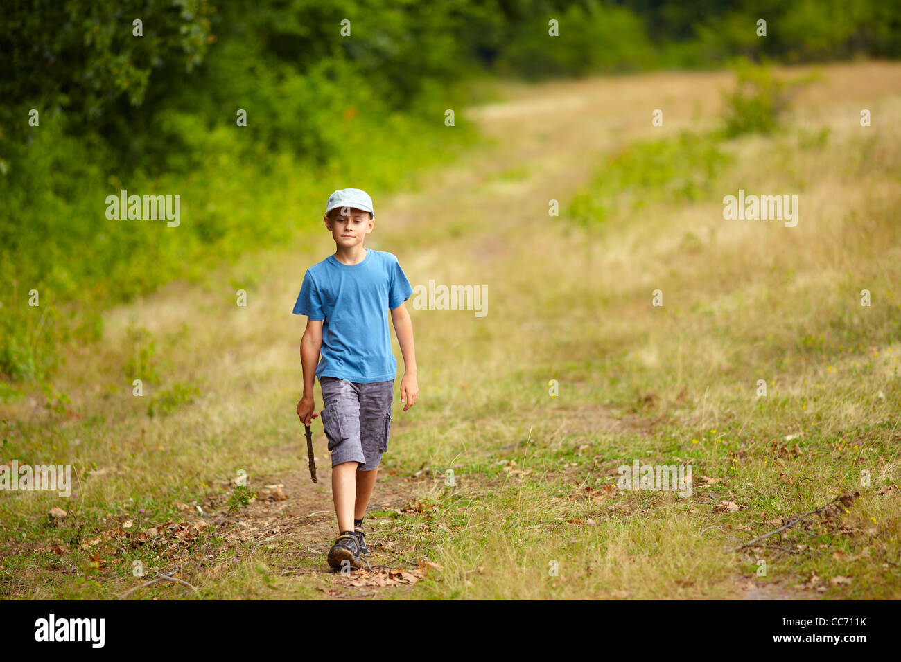 Full length portrait of a boy walking outdoor in a forest Stock Photo ...