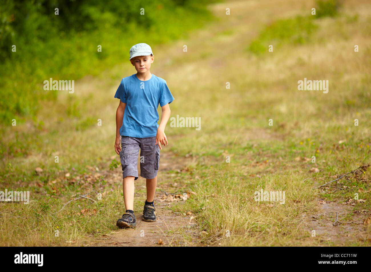 Full length portrait of a boy walking outdoor in a forest Stock Photo ...