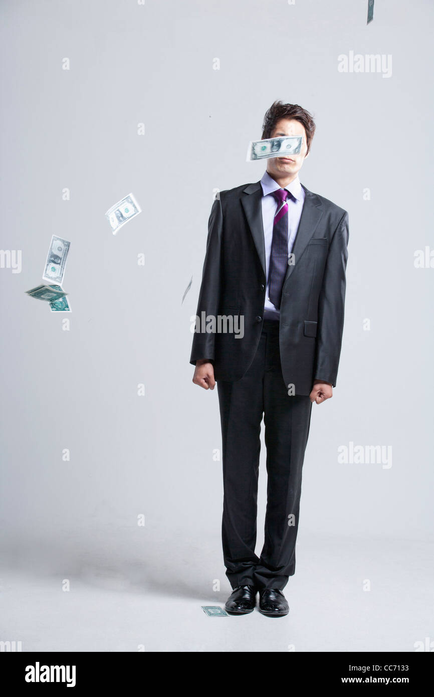 A man hard to stand and flying money Stock Photo - Alamy
