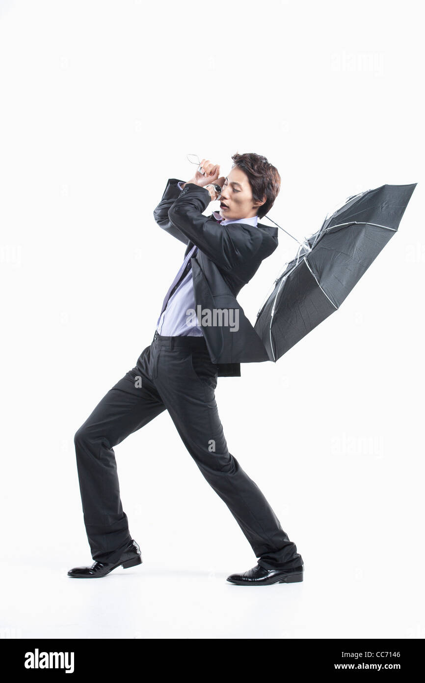 A man hit by the strong wind with an umbrella inside out Stock Photo ...