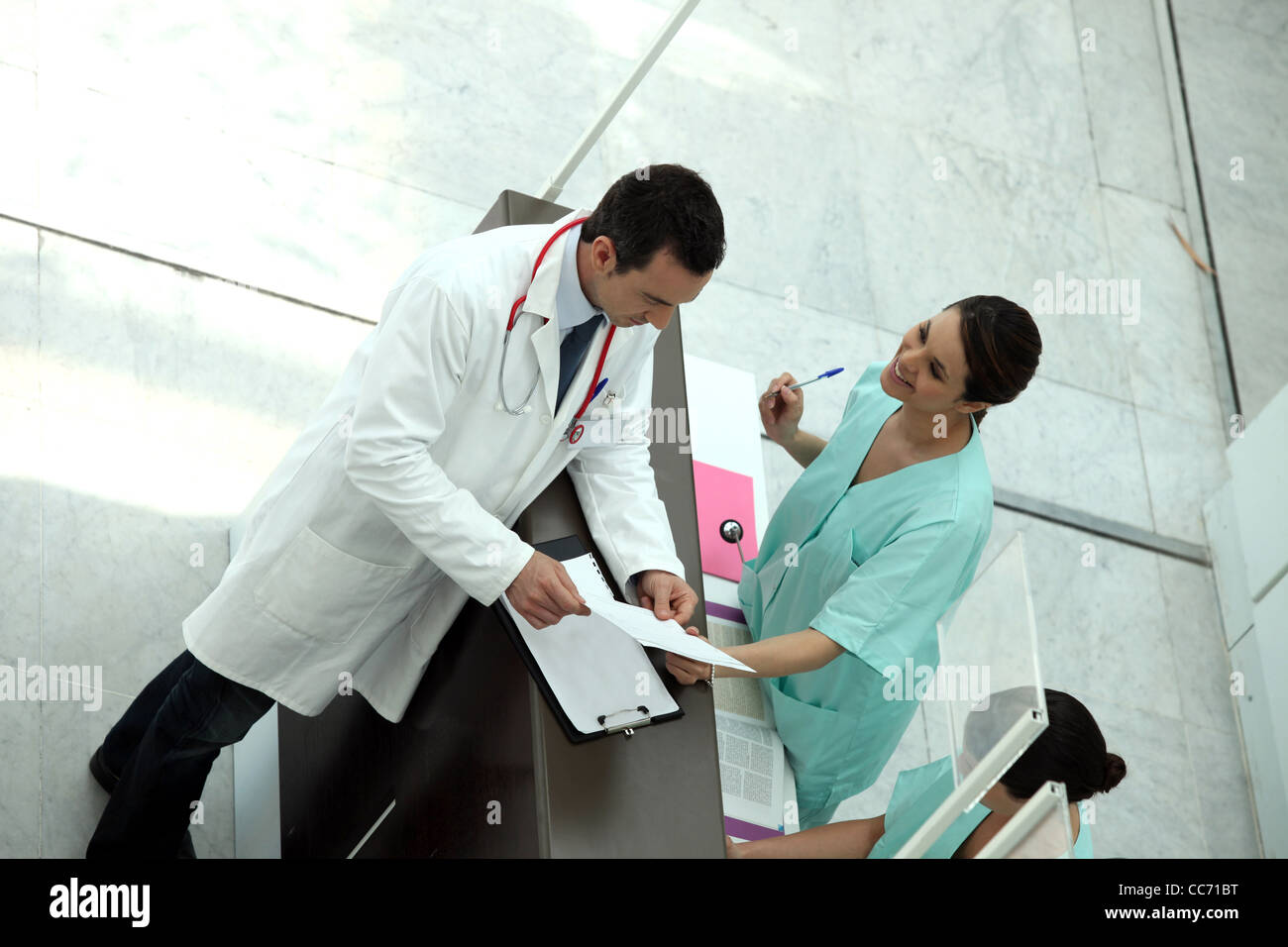 Medical secretary showing record to doctor Stock Photo - Alamy