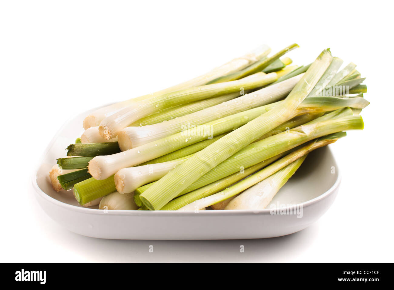 Closeup of freshly cut leek isolated on white background Stock Photo ...