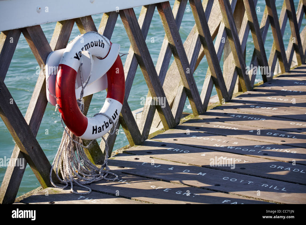 Yarmouth Harbour lifebuoy lifering life ring on pier showing dedication ...