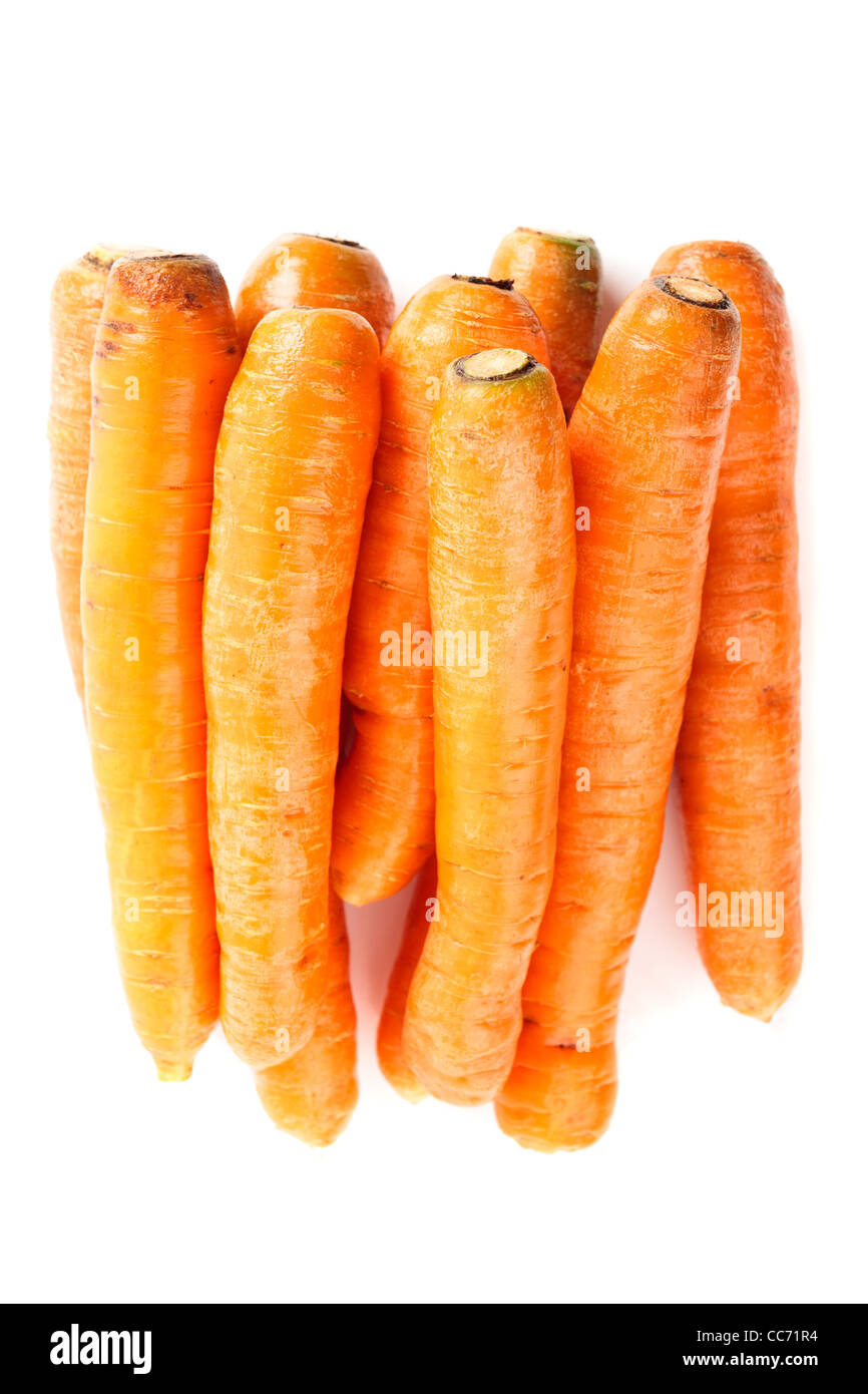 Closeup of a pile of carrots isolated on white background Stock Photo ...