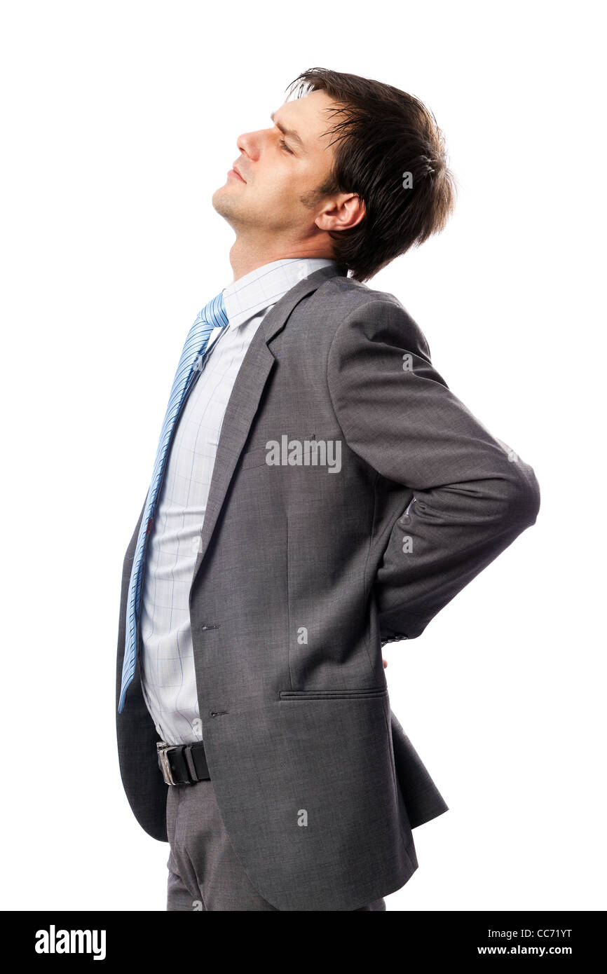 Young businessman with strong back pain, isolated on white background ...