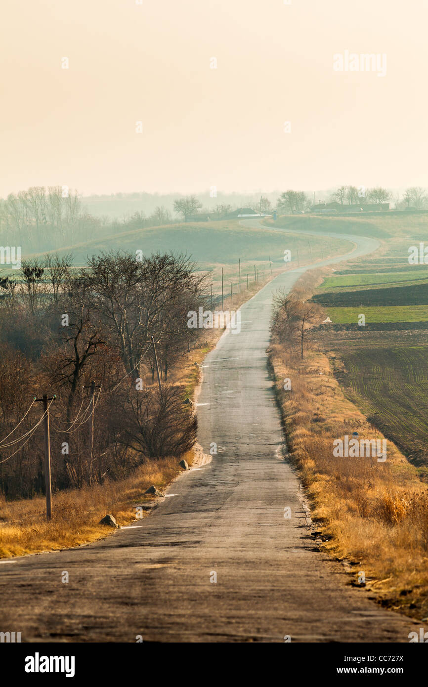 Rural landscape with an empty road and overcast sky Stock Photo - Alamy
