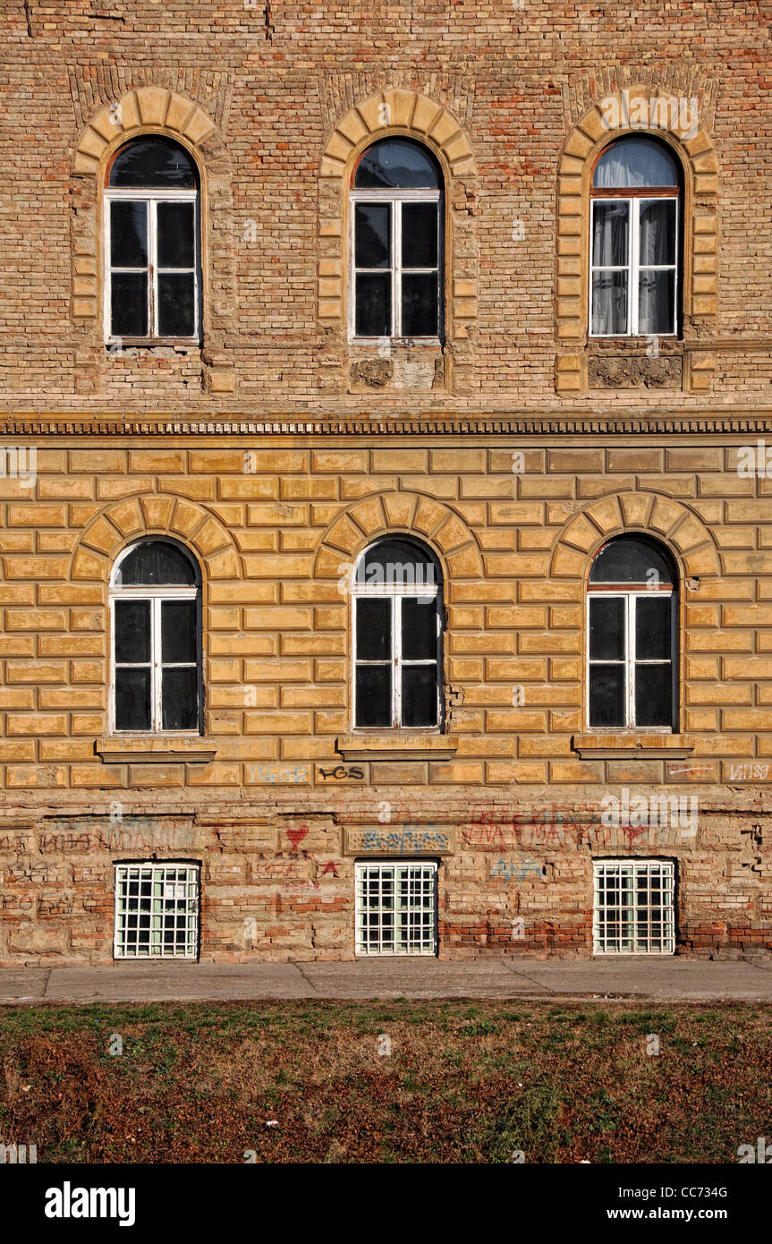 VArious windows on an old yellow building Stock Photo - Alamy