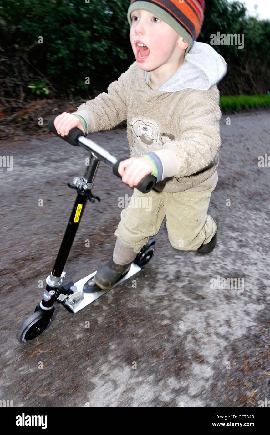 A young boy on a scooter Stock Photo - Alamy