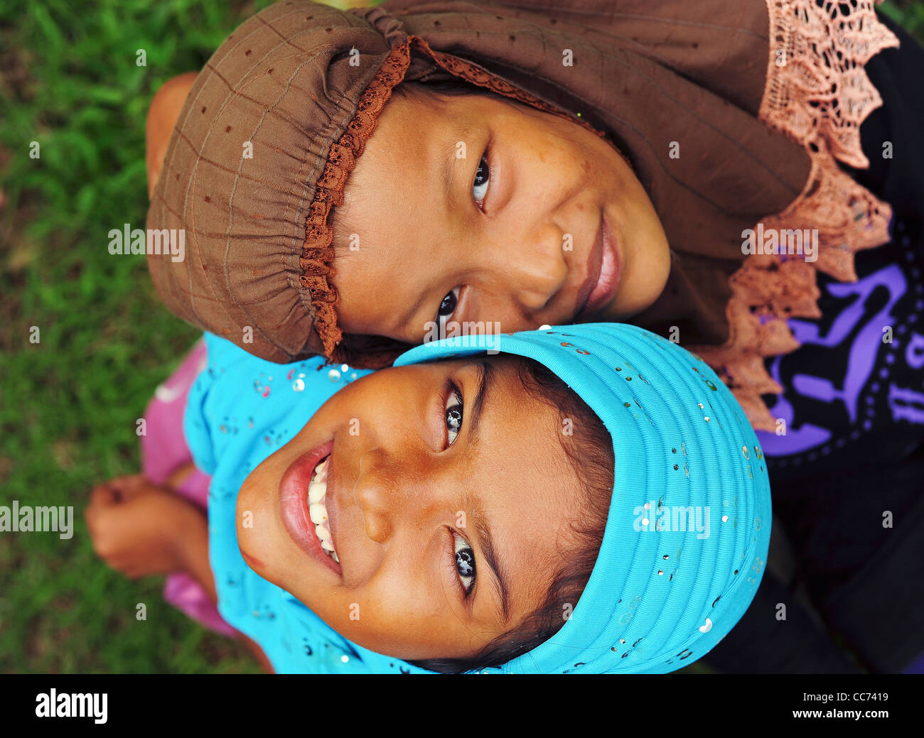 Indonesia, Sumatra, Banda Aceh, two smiling girls looking up with ...