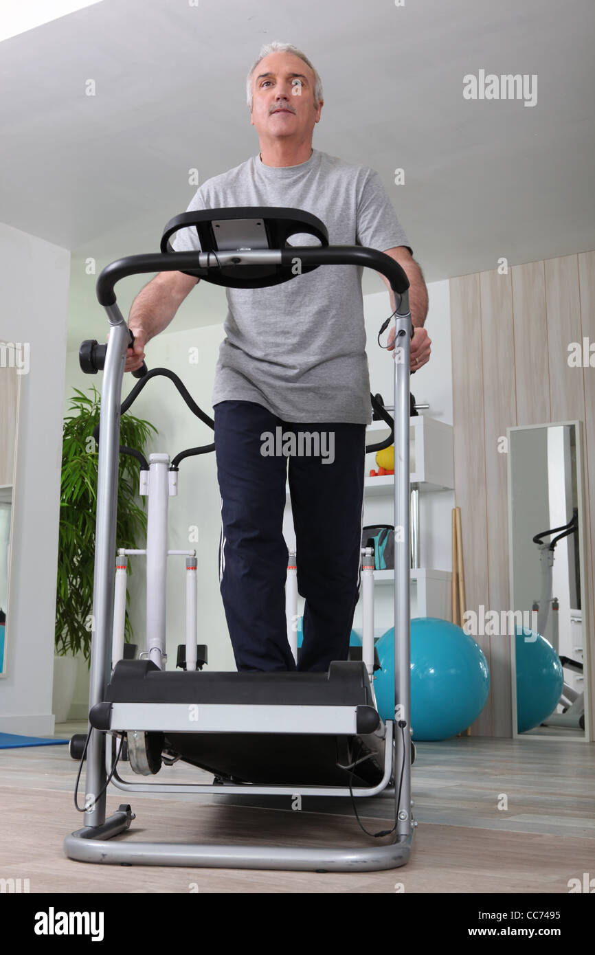 Middle-aged man on treadmill at home Stock Photo - Alamy