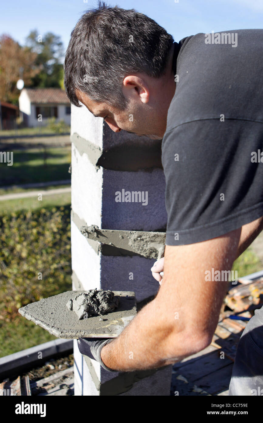 Man building wall Stock Photo - Alamy