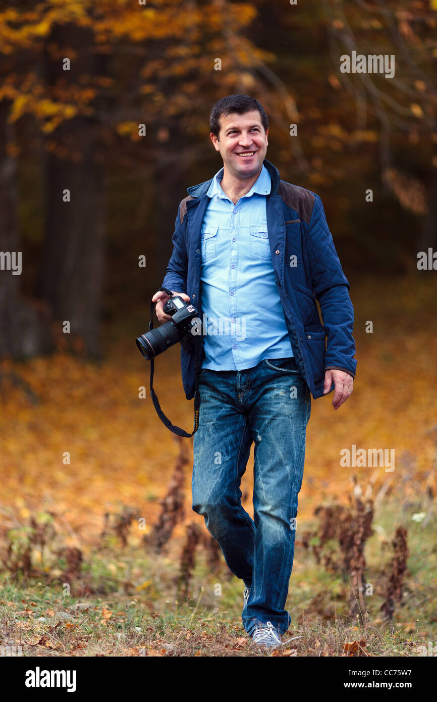 Professional nature photographer taking photos in the forest in an ...