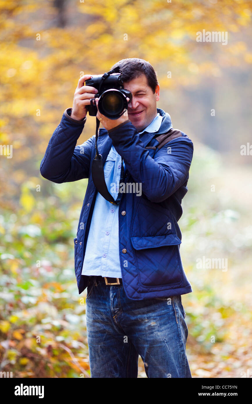 Professional nature photographer taking photos in the forest in an ...
