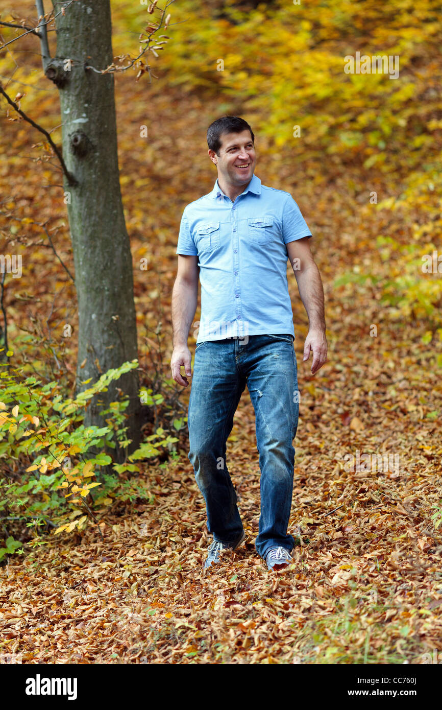Portrait of a man walking into the forest Stock Photo - Alamy