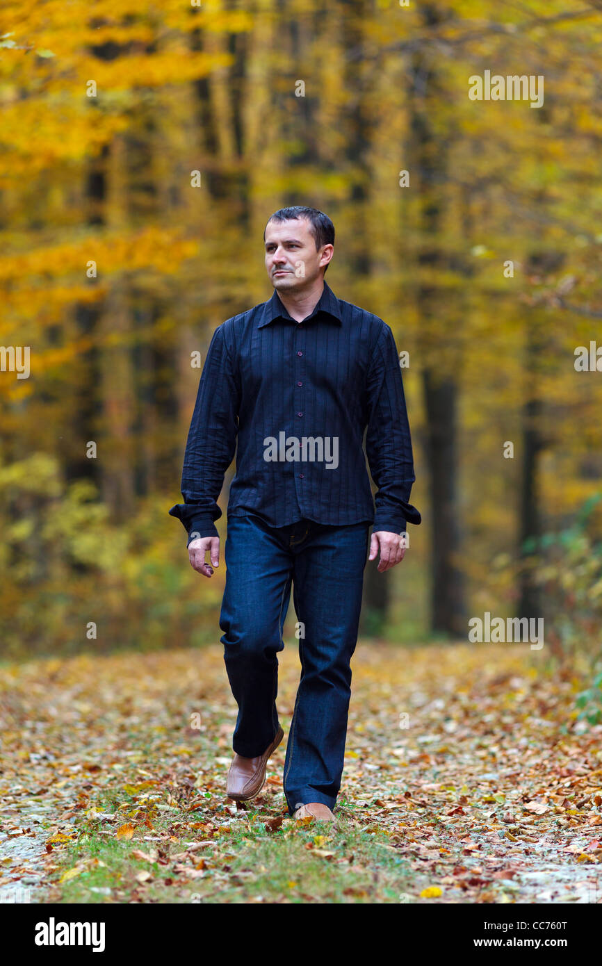Portrait of a man walking into the forest Stock Photo - Alamy