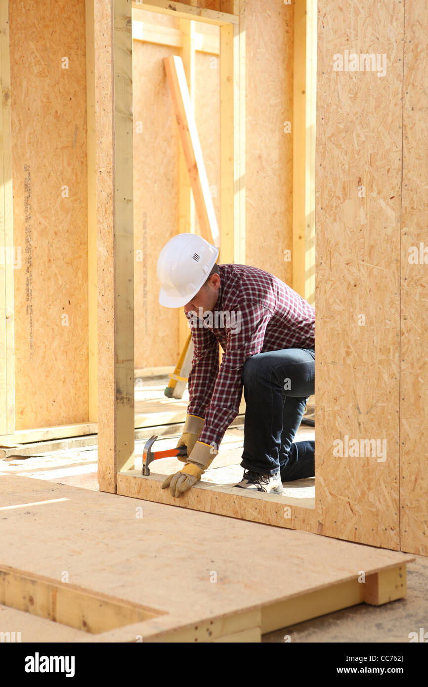 Man hammering nail Stock Photo - Alamy