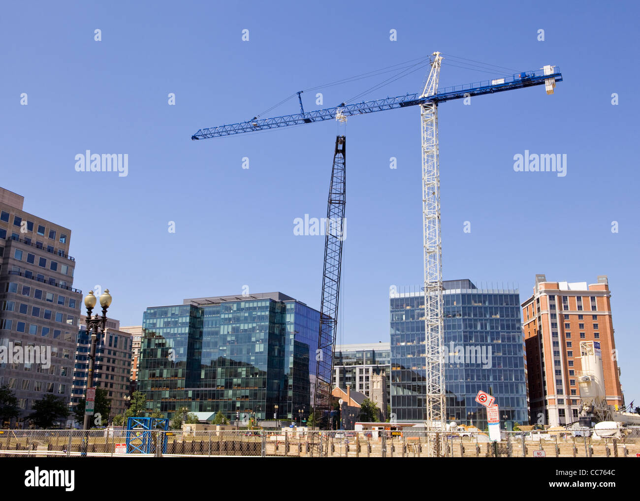 Cranes erected over an urban construction site Stock Photo - Alamy