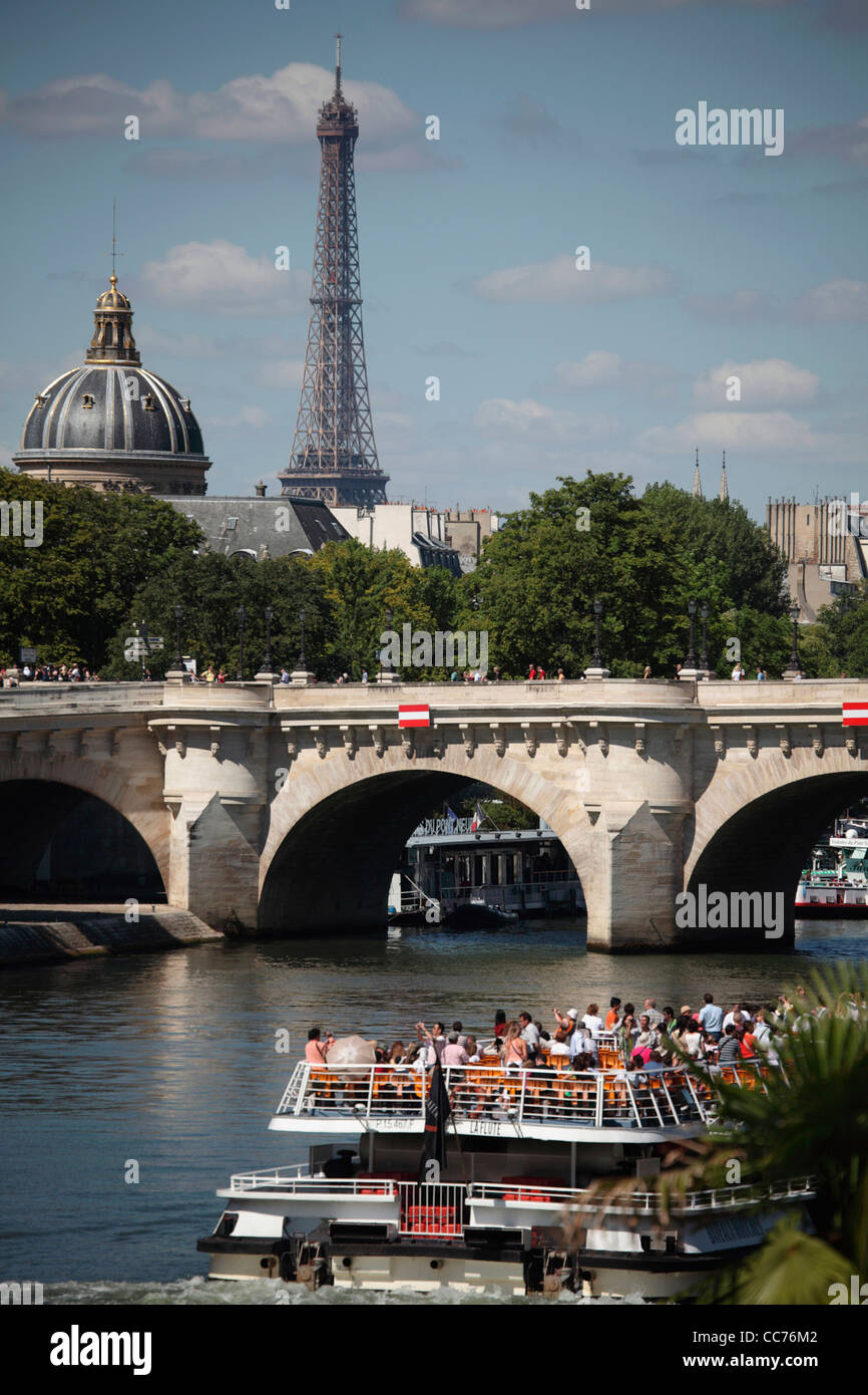 France, Paris, Tour boat in River Seine with Pont Neuf and Eiffel Tower ...