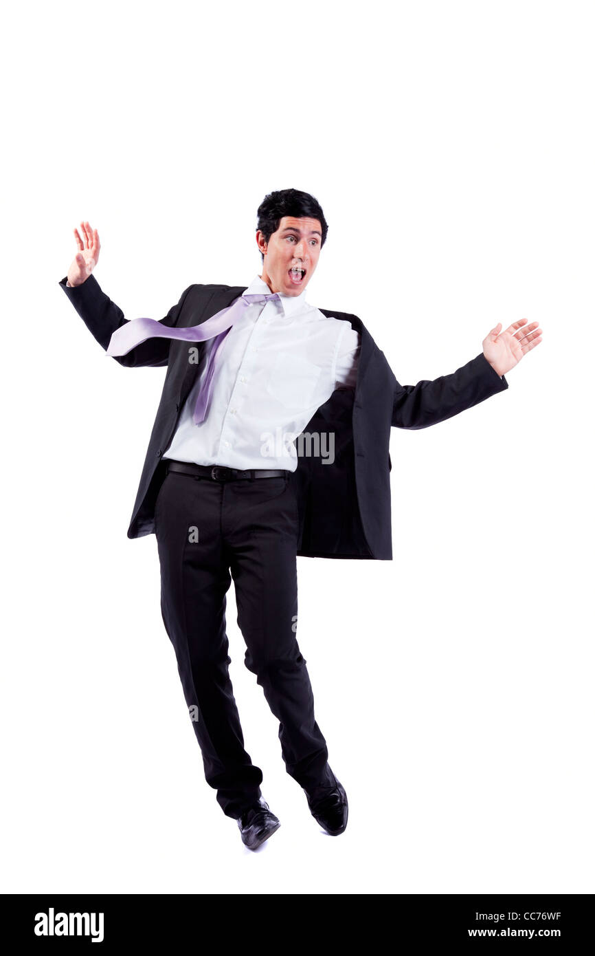 Scared businessman in a falling position (isolated on white Stock Photo ...