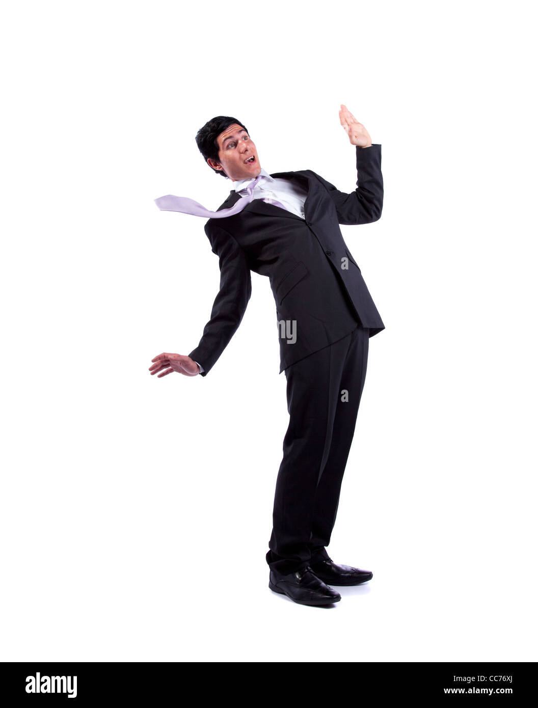 Scared businessman in a falling position (isolated on white Stock Photo ...