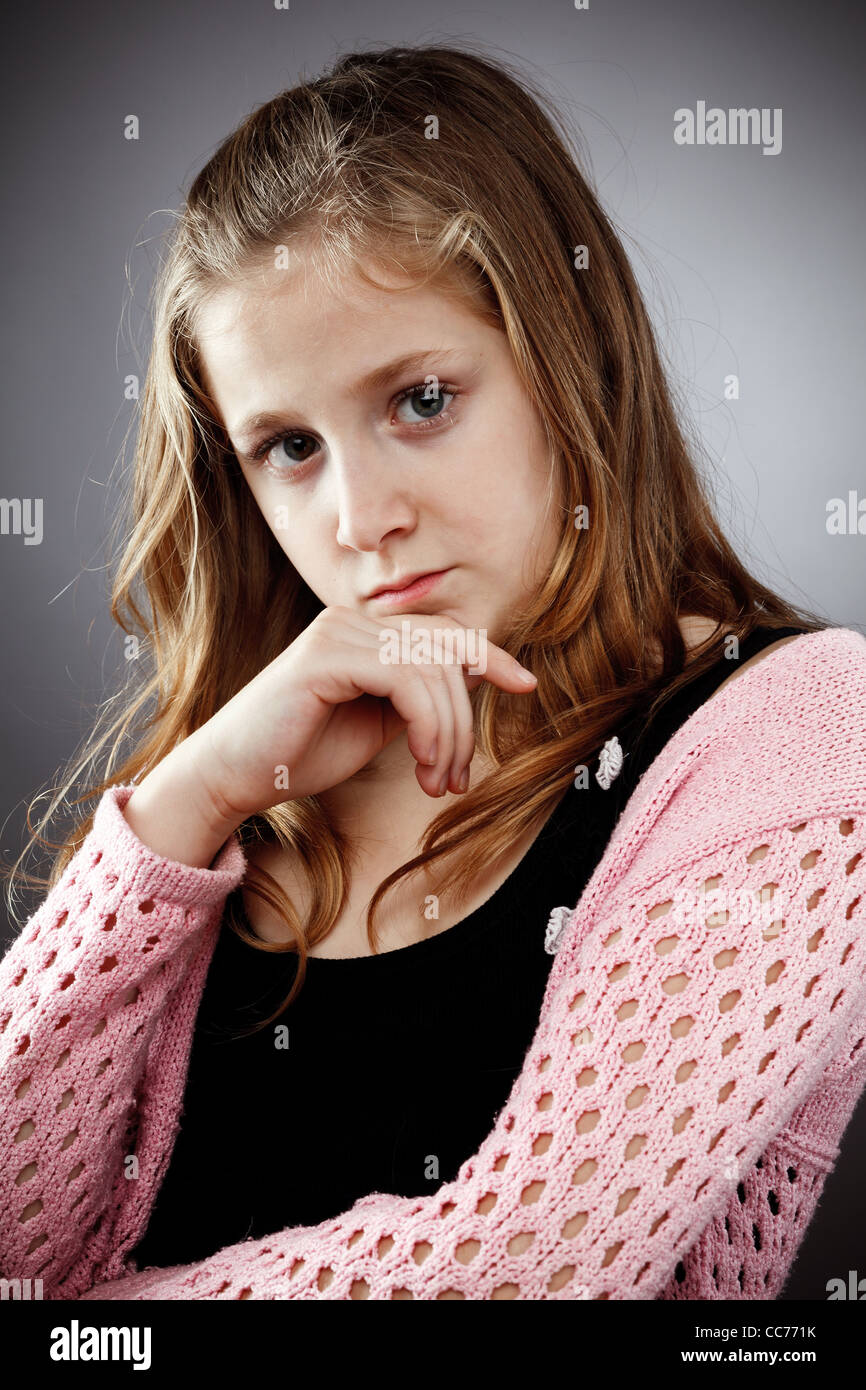 Sad girl studio closeup portrait on gray background Stock Photo - Alamy