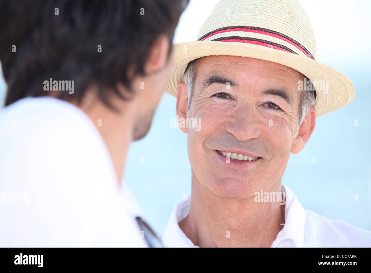 Smiling men in the sunshine Stock Photo - Alamy