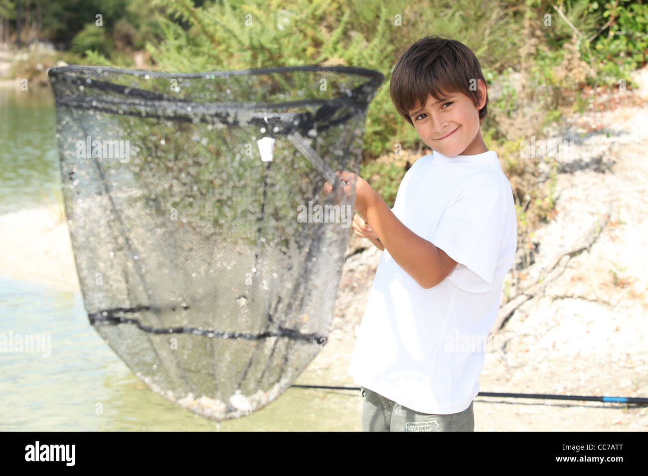 Boy with a huge fishing net Stock Photo - Alamy