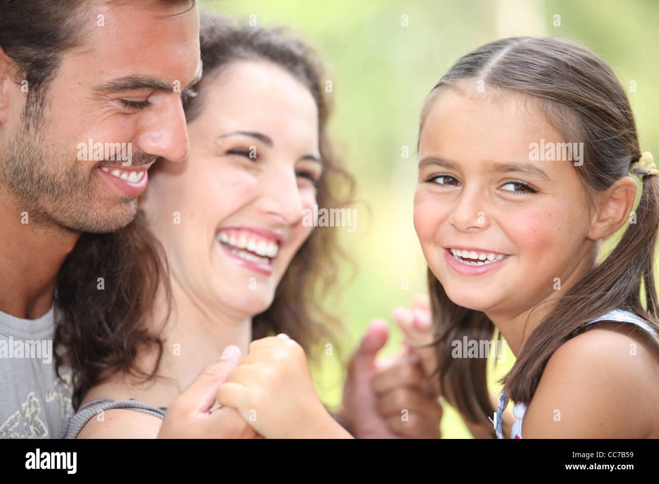 Parents laughing with their daughter Stock Photo - Alamy