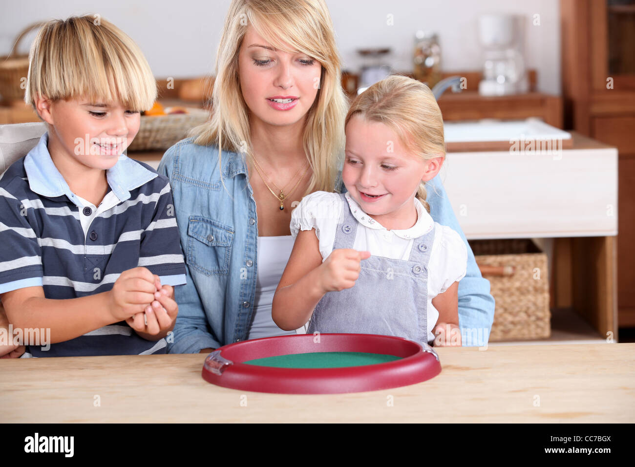 Family playing dice game Stock Photo - Alamy