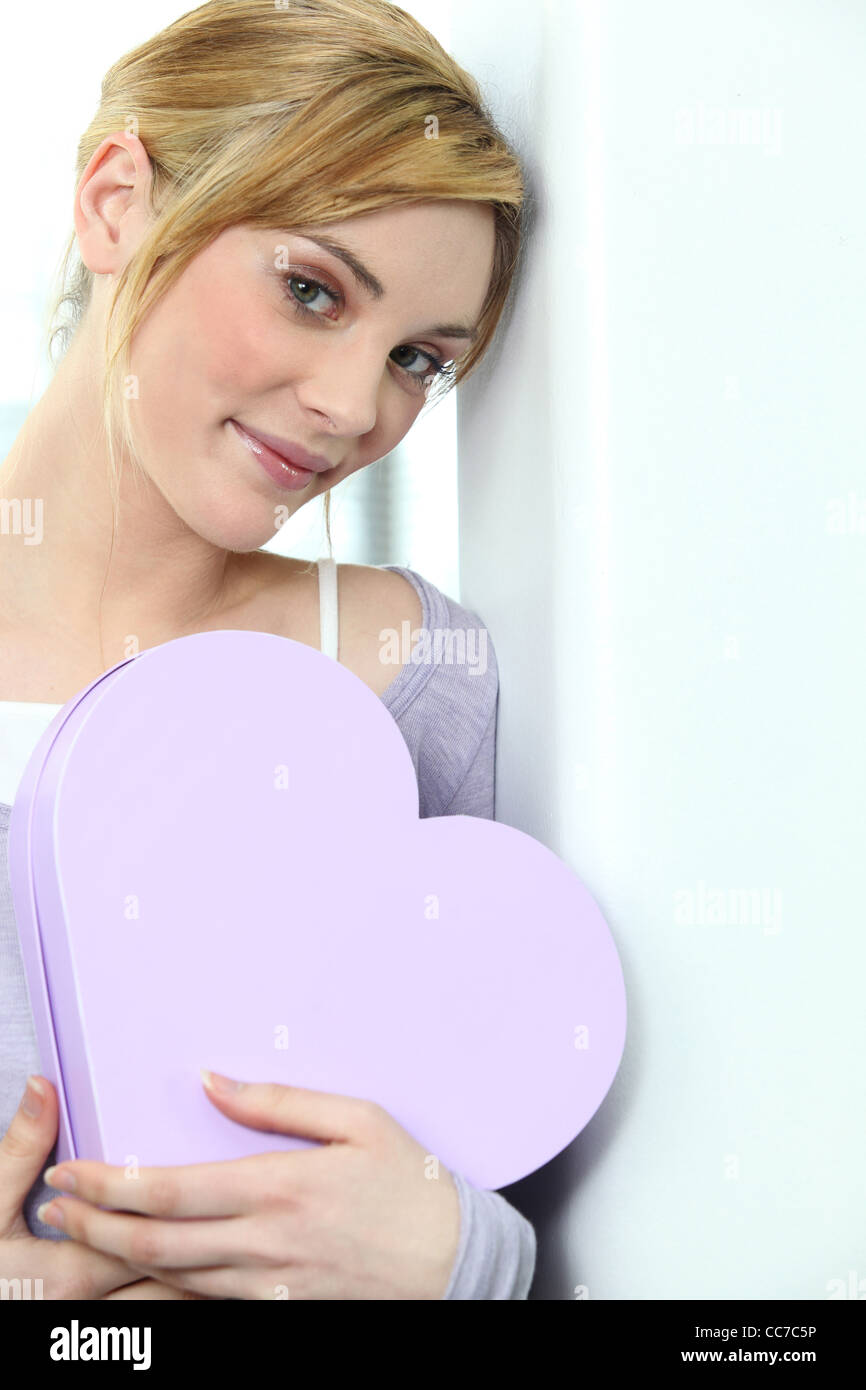 a blonde woman with a heart shaped box Stock Photo - Alamy