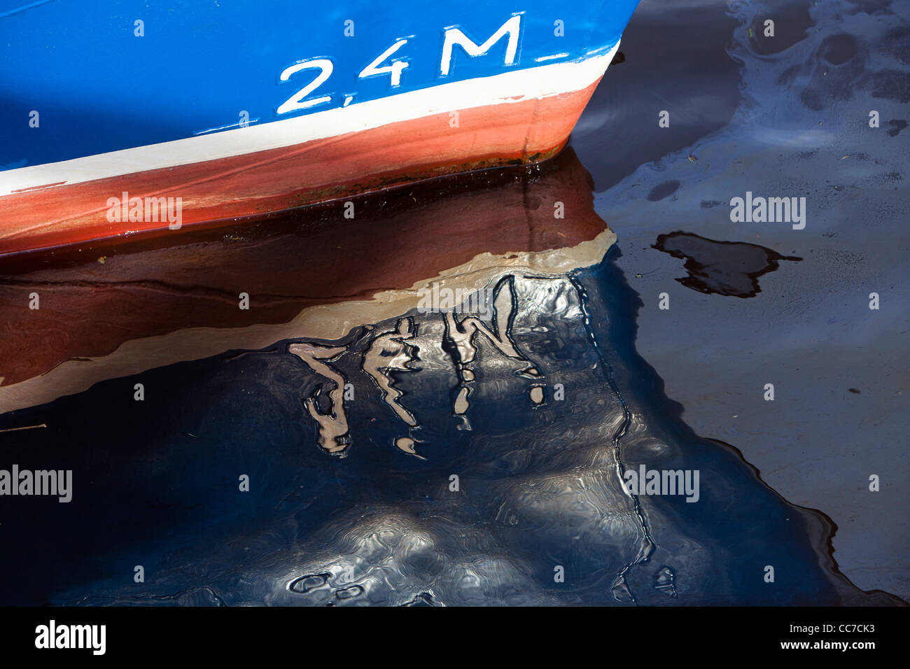 Reflections, of Fishing Boat in Harbour Water Polluted with Diesel Oil ...