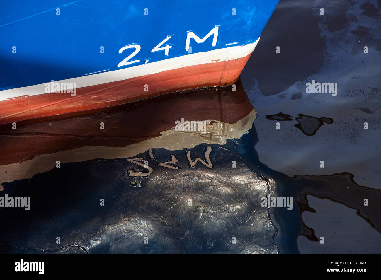 Reflections, of Fishing Boat in Harbour Water Polluted with Diesel Oil ...