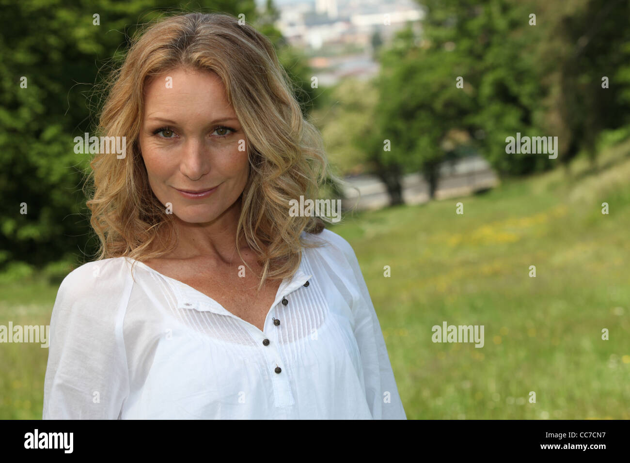 Woman stood in park Stock Photo - Alamy