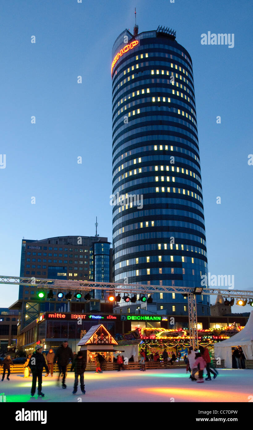 Ice rink at the Christmas market in front of the JenTower at night ...